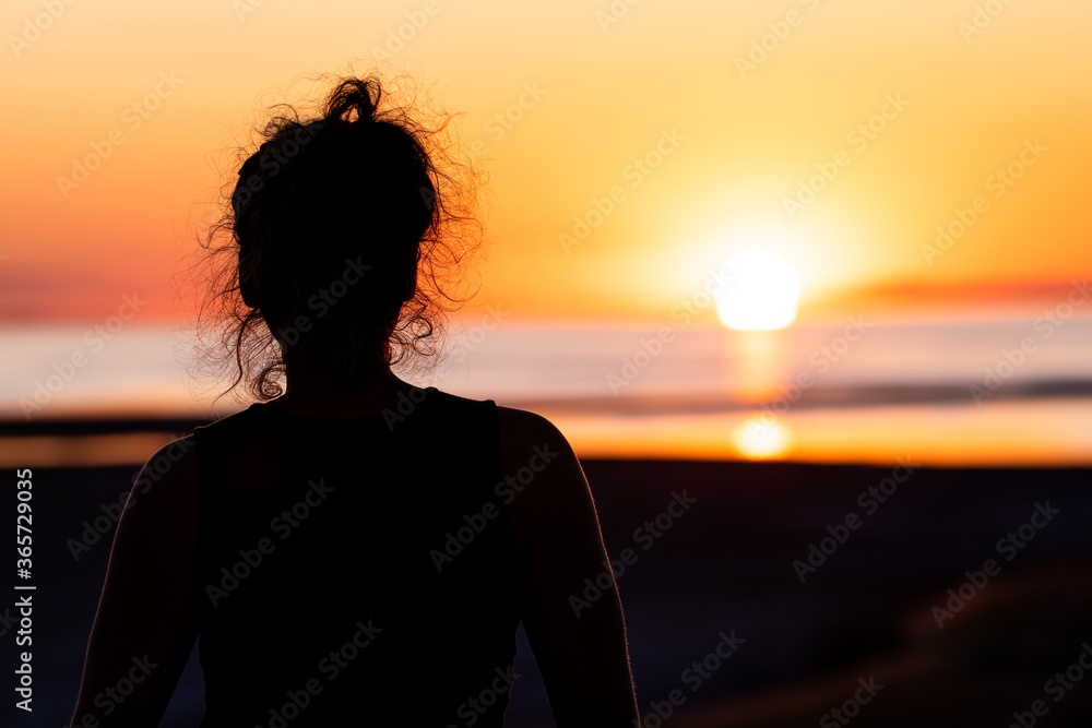 Woman back watching sun path reflection sunset on Great Salt Lake in ...