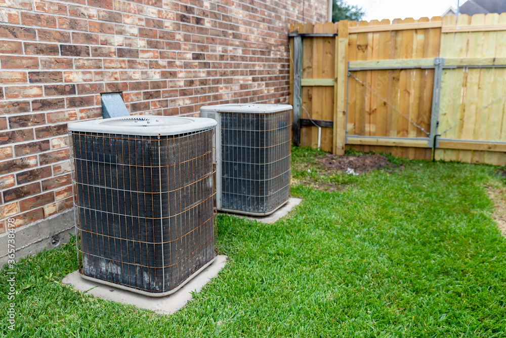 Older air conditioner units next to brick home with copy space Stock ...