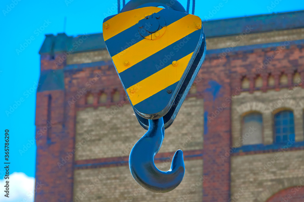 Heavy duty iron hook in a black and yellow fixation in front of an ...