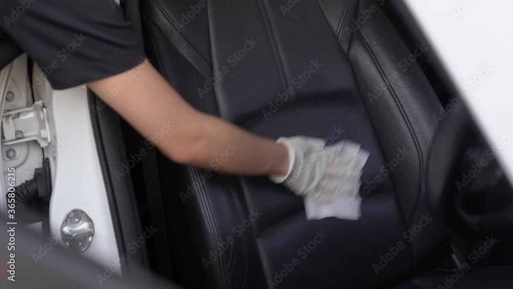 woman cleaner wear white gloves disinfect in car front seat spray and ...