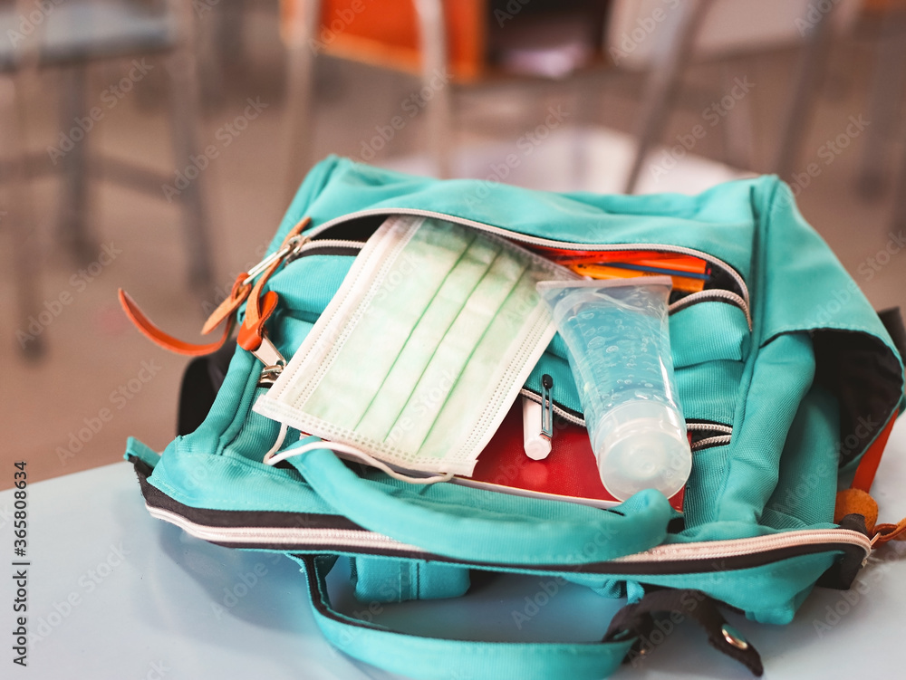 COVID-19 prevention , back to school and new normal concept.Backpack ...