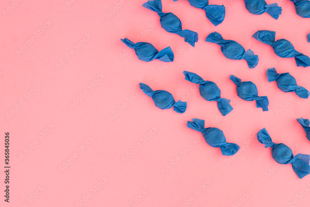Wrapped with blue candy paper in bonbon shape candies,on the pink ...