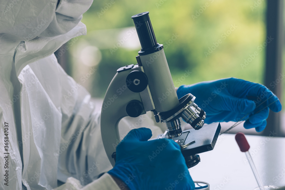 Lab Technician in Personal protective equipment PPE suit Vaccines ...