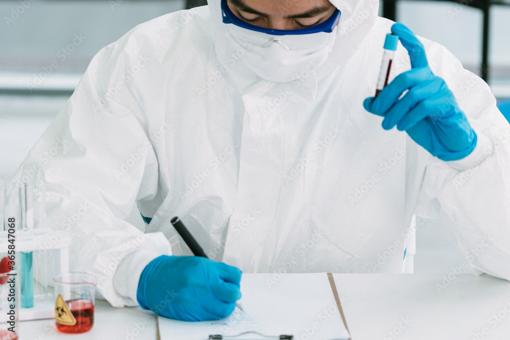 Lab Technician in Personal protective equipment PPE suit Vaccines ...