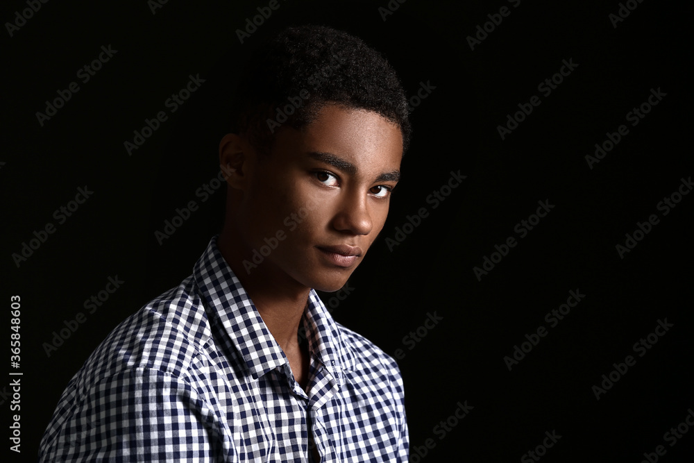 Sad African-American teenage boy on dark background. Stop racism Stock ...