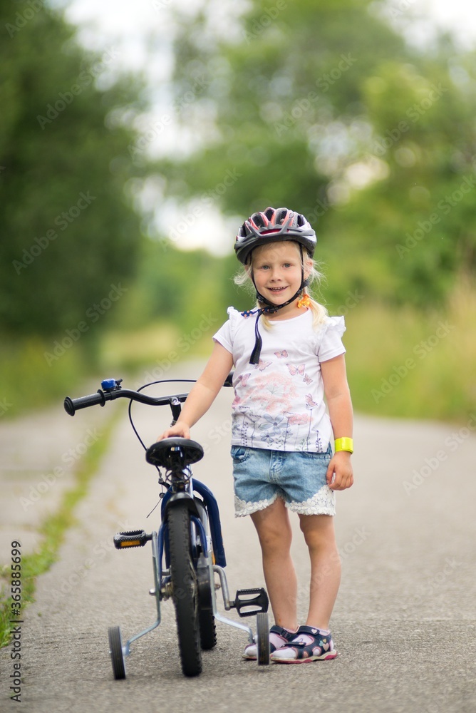 The first bike ride a little girl learns to ride a bicycle. Stock Photo ...