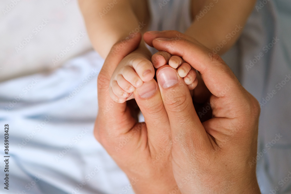 Little feet of the kid in the male hands of the dad Stock Photo | Adobe ...