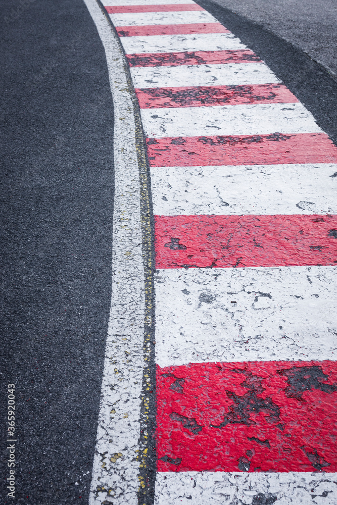 A white line on the right side of asphalt road with red and white ...