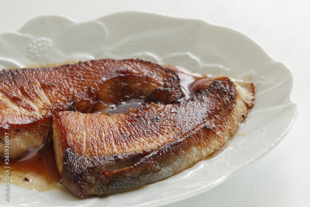 Japanese food, pan fried yellow tail Buri fish served soy sauce Stock ...