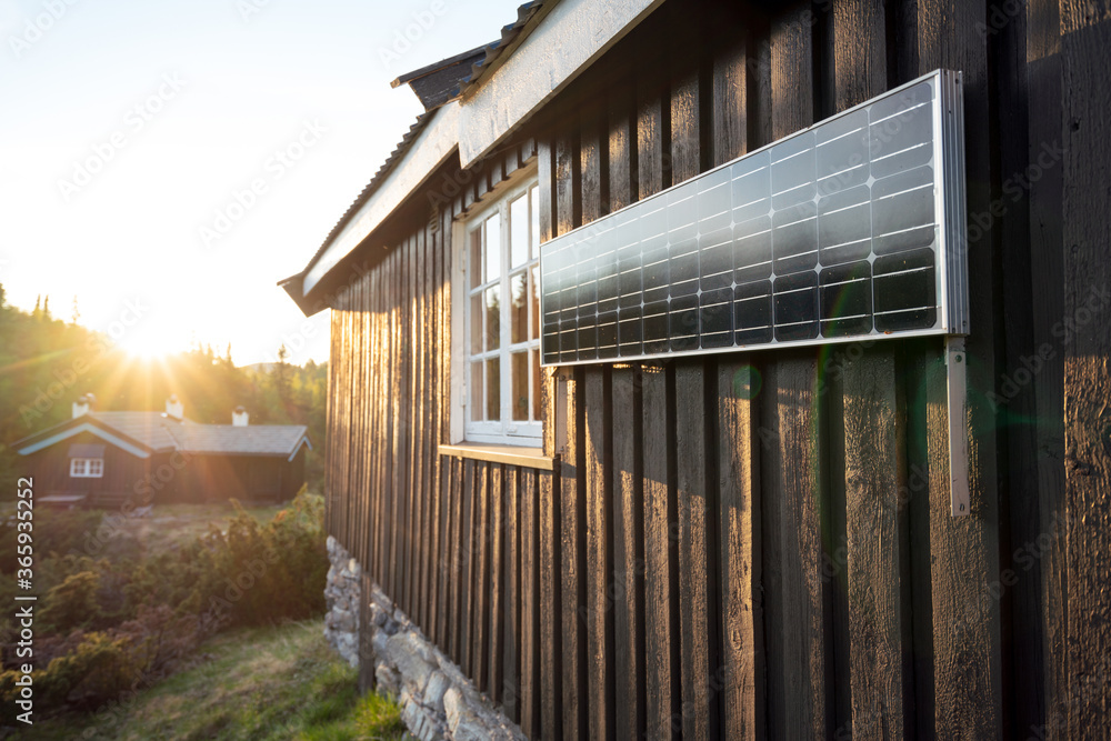 Solar panels hanging on cabin wall outdoors in the wilderness during ...
