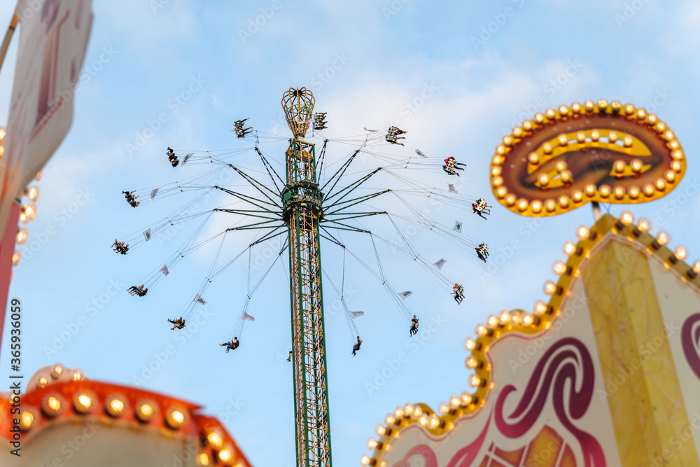 Low angle view of Drop tower ride with exciting people on the seat ...