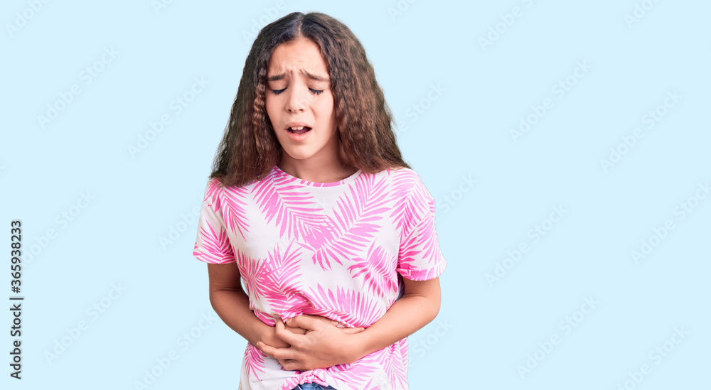 Cute hispanic child girl wearing casual clothes with hand on stomach ...