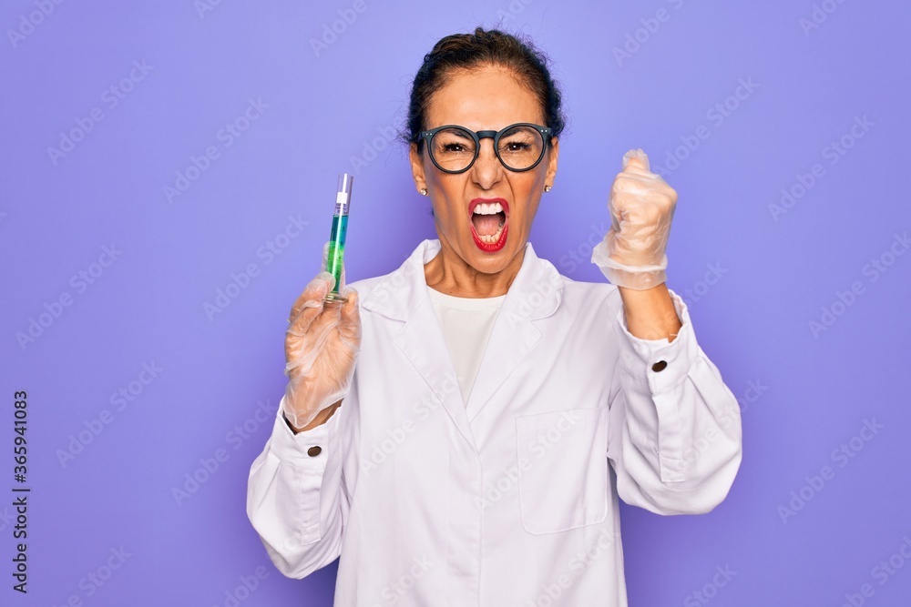 Middle age senior scientist woman wearing laboratory coat holding ...