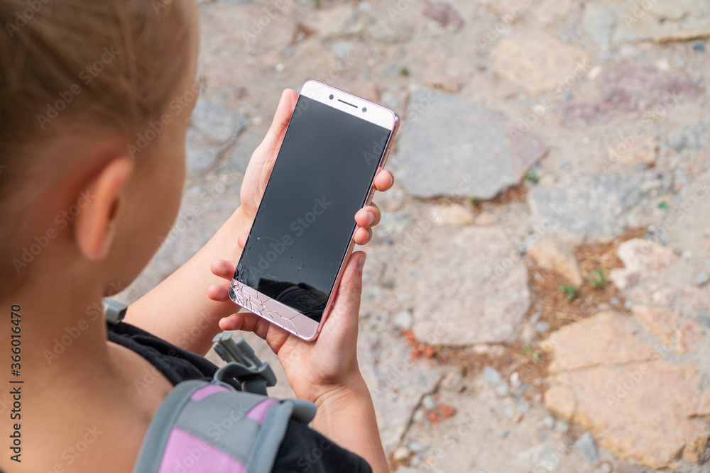 schoolgirl with broken phone Stock Photo | Adobe Stock
