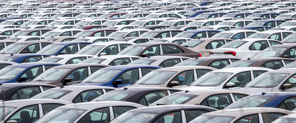 Rows of a new cars parked in a distribution center on a car factory on ...