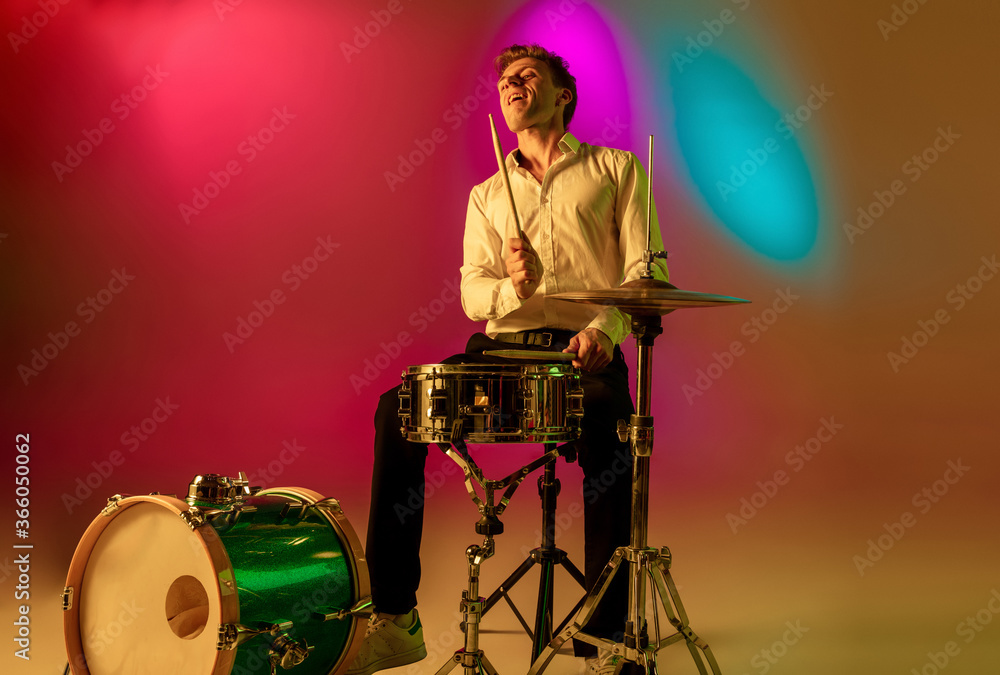 Cheerful. Young caucasian inspired and expressive musician, drummer ...