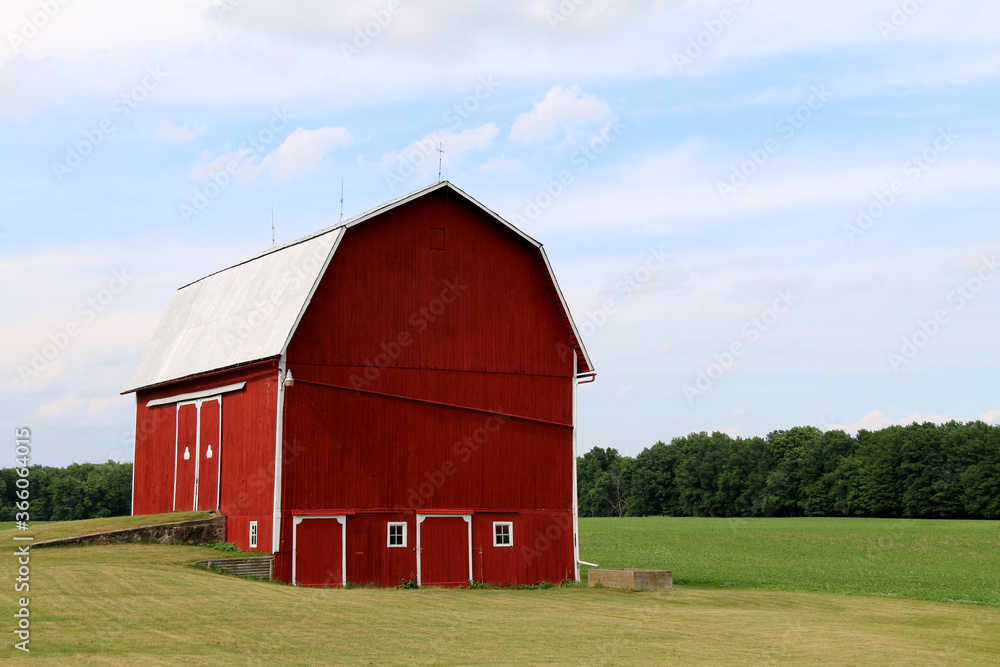 a large white roof red barn with bright white trim and nature loading ...