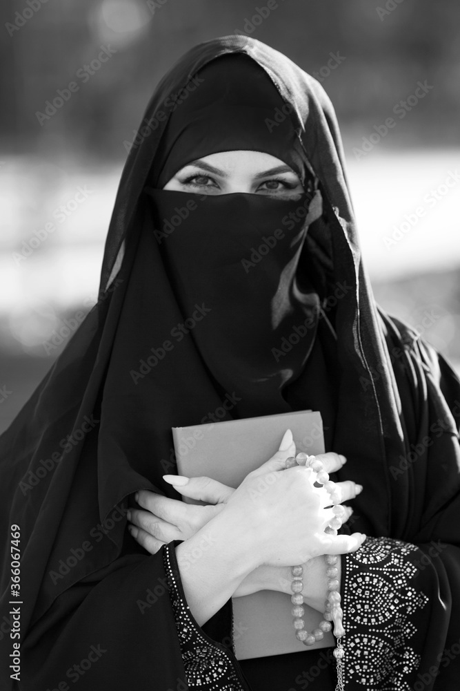 Foto de A woman holds in her hands the holy book of Karan with prayers ...