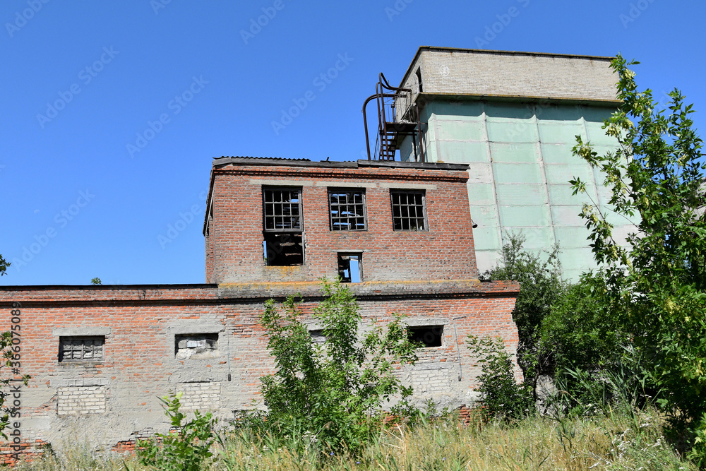 An old abandoned factory. Brick wall and destructible building of a ...