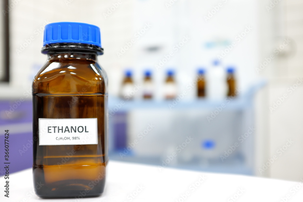 Selective focus of ethanol or ethyl alcohol brown amber glass bottle ...