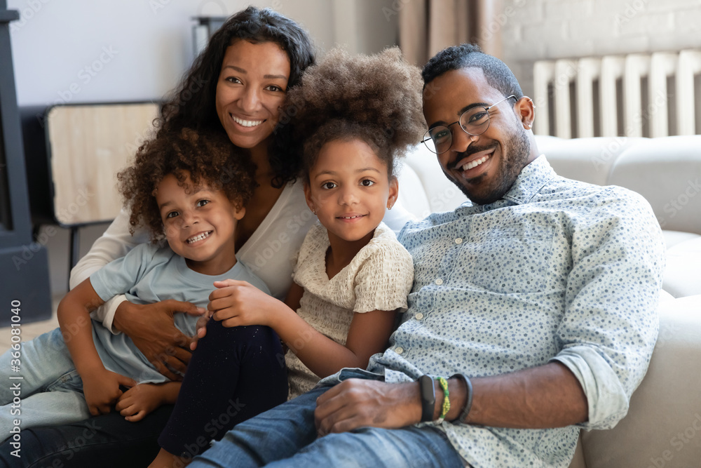 Portrait of smiling young african American family with two small kids ...