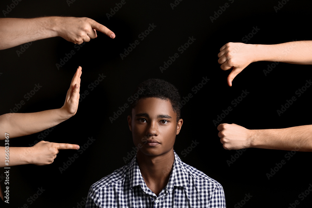 People bullying African-American teenage boy on dark background. Stop ...