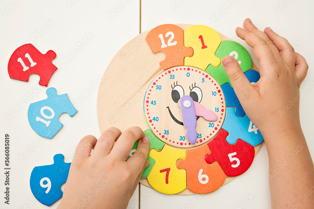Boy learning time with wooden clock. Toy for Learning method for ...