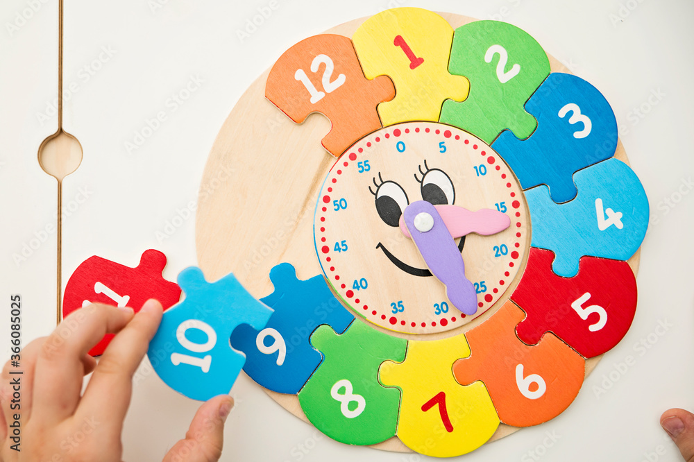 Boy learning time with wooden clock. Toy for Learning method for ...