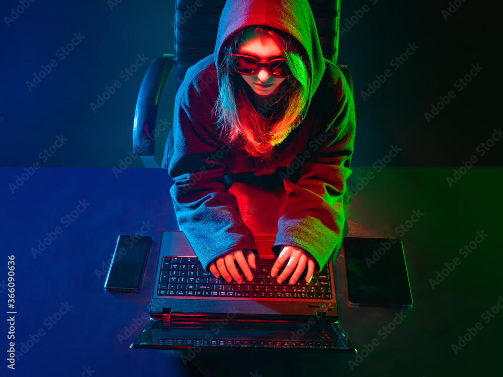 Girl is a hacker. Girl next to a laptop top view. Hacker attack. Woman ...