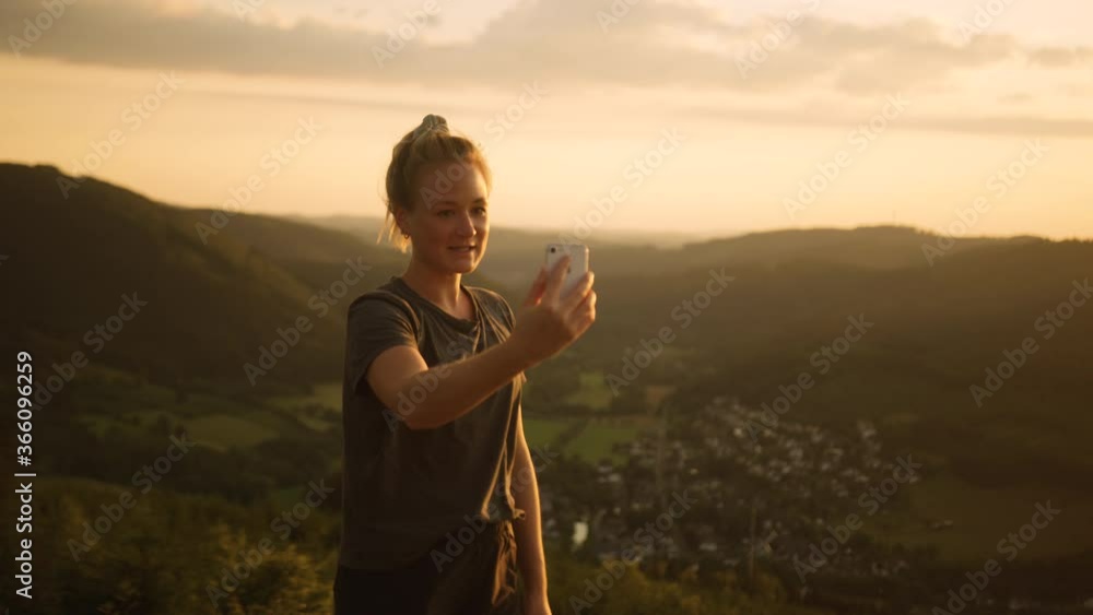 Outdoor Influencer creating instagram story on top of mountain for ...