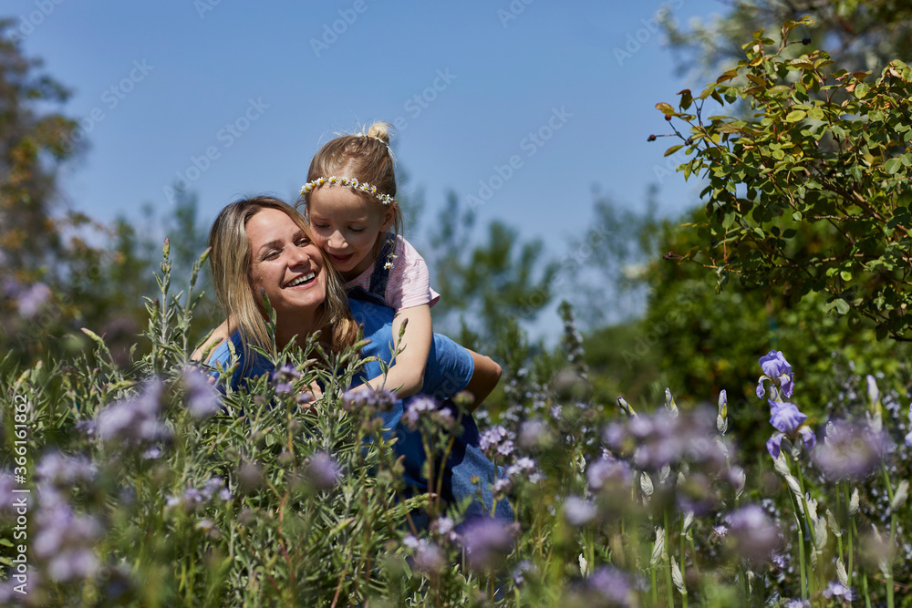 Happy mother carrying daughter piggyback in allotment garden Stock ... Happy mother carrying daughter piggyback in allotment garden Stock ...