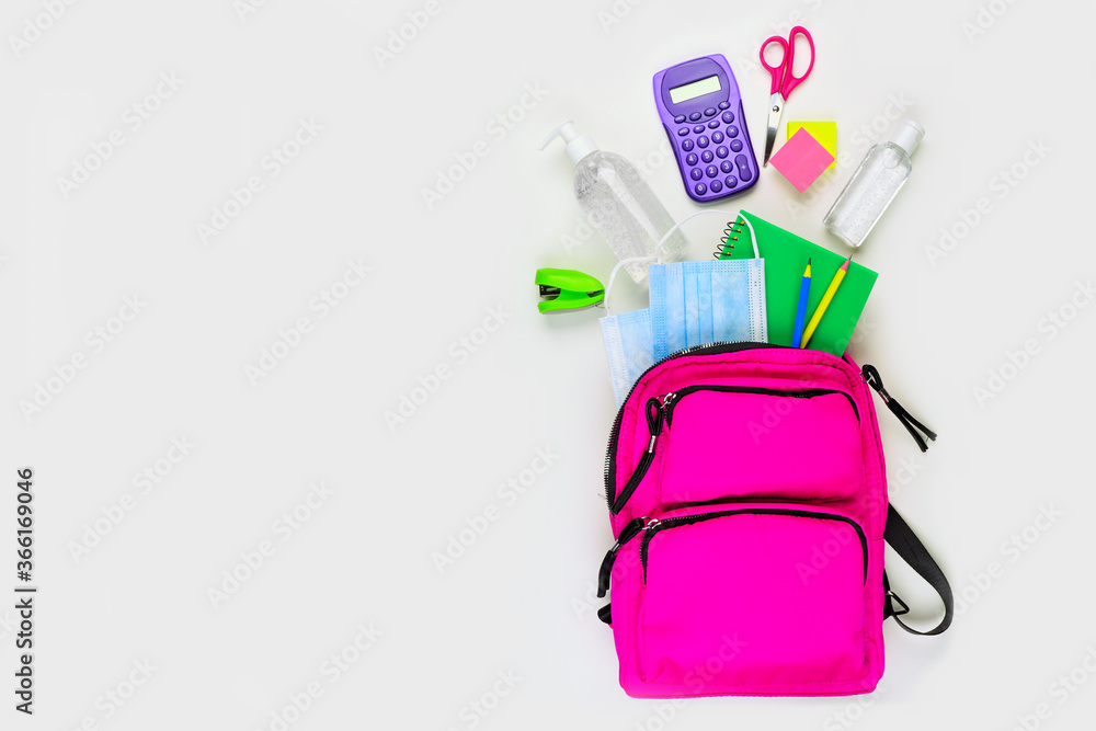 Backpack with school supplies and COVID 19 prevention items. Top view ...