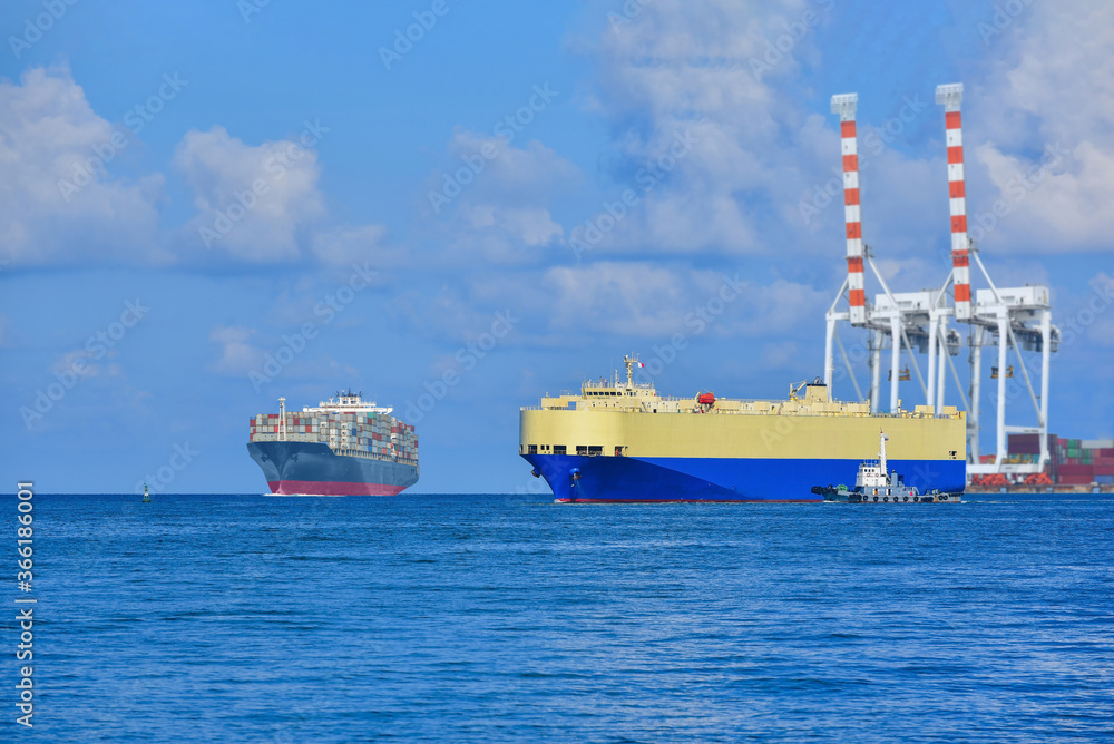 Auto carrier ship at sea with Tug boat towing assistance ...