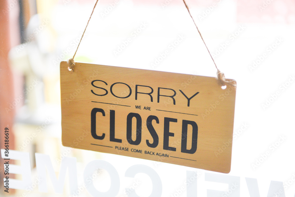 Closed shop sign - Sorry we're closed sign hanging on cafe glass door ...