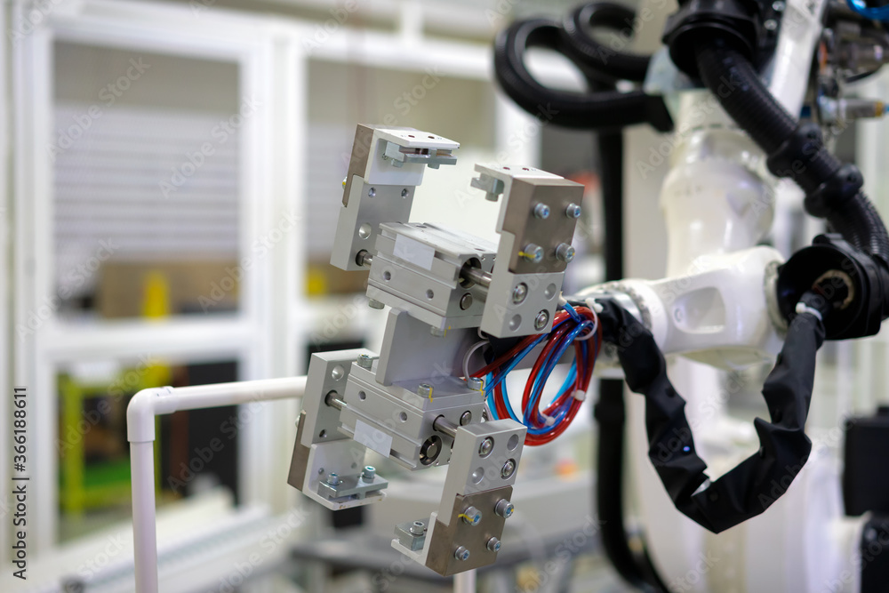 Factory 4.0 concept: View of gripper unit on handerling robot arm of ...