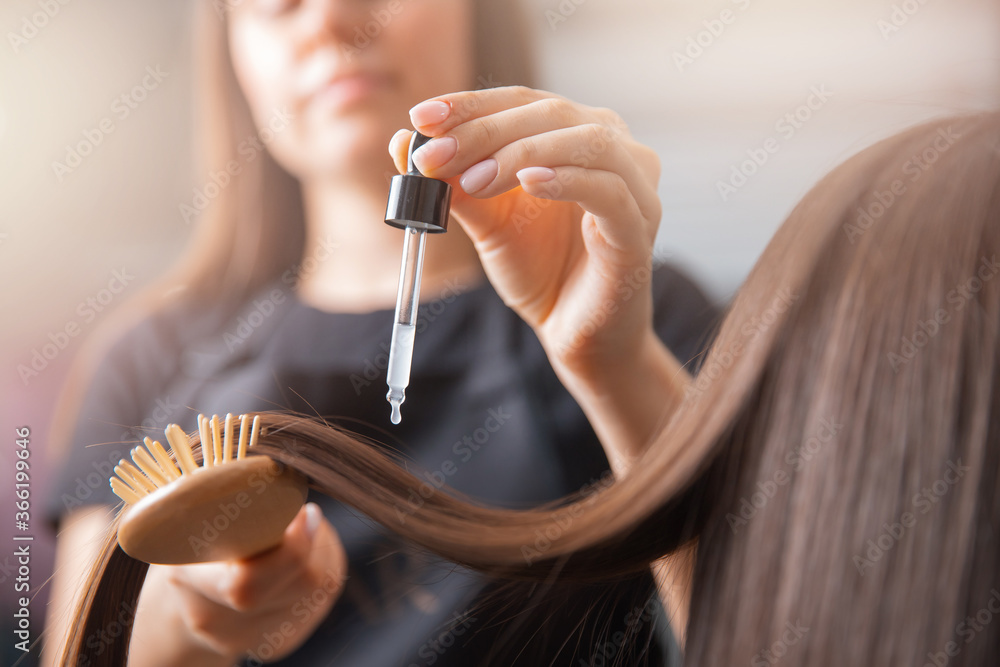 Master hairdresser procedure oil hair treatment for woman. Concept spa ...