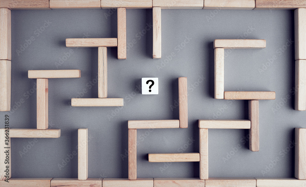 Maze or labyrinth made with wooden blocks with a wooden cube with ...
