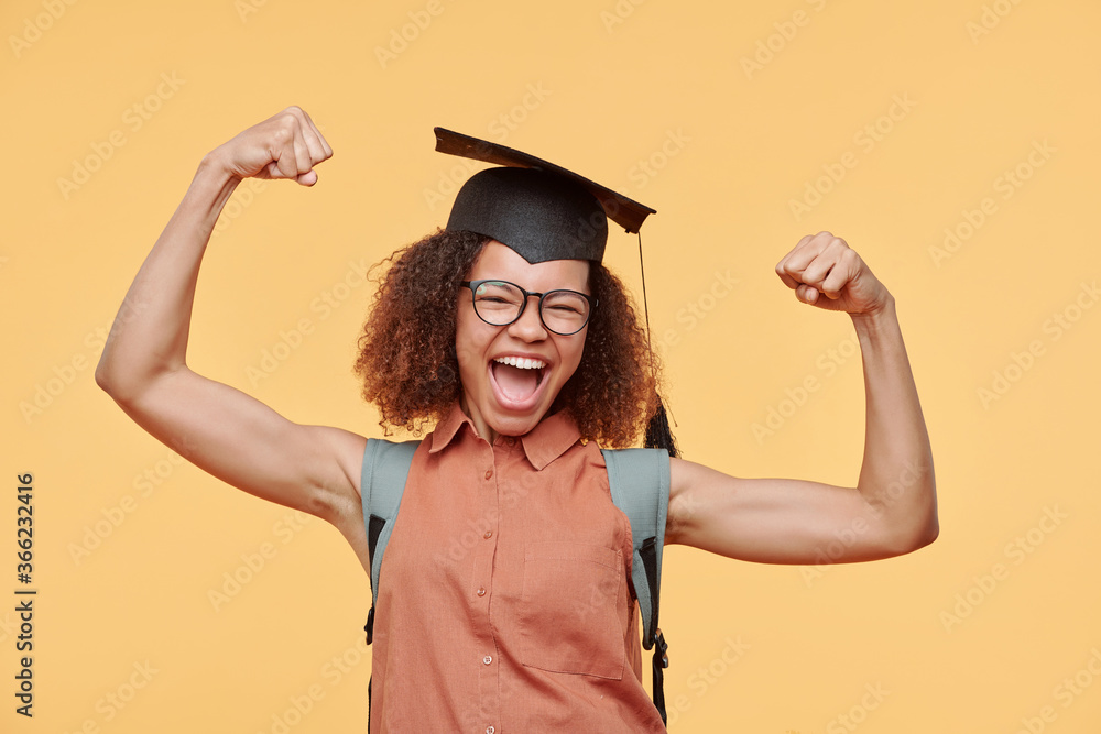 Ecstatic African-American graduate student in cap and eyeglasses ...