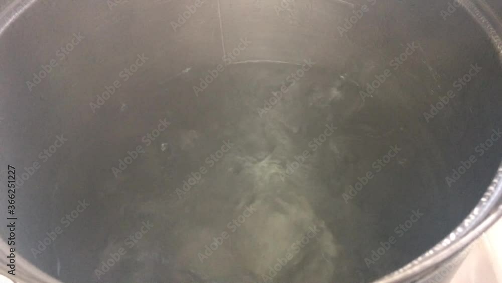 Boil hot water in a stainless steel pot . Boiling hot water in a ...