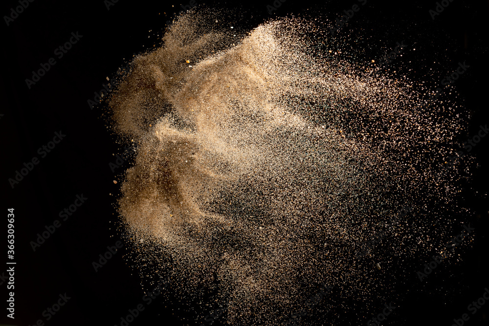 Abstract sand explosion art on black background, sand splash. Stock ...