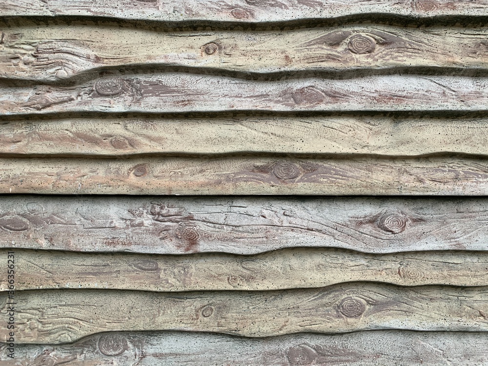 Plank-shaped concrete fence. Imitation of wooden slats on a concrete ...