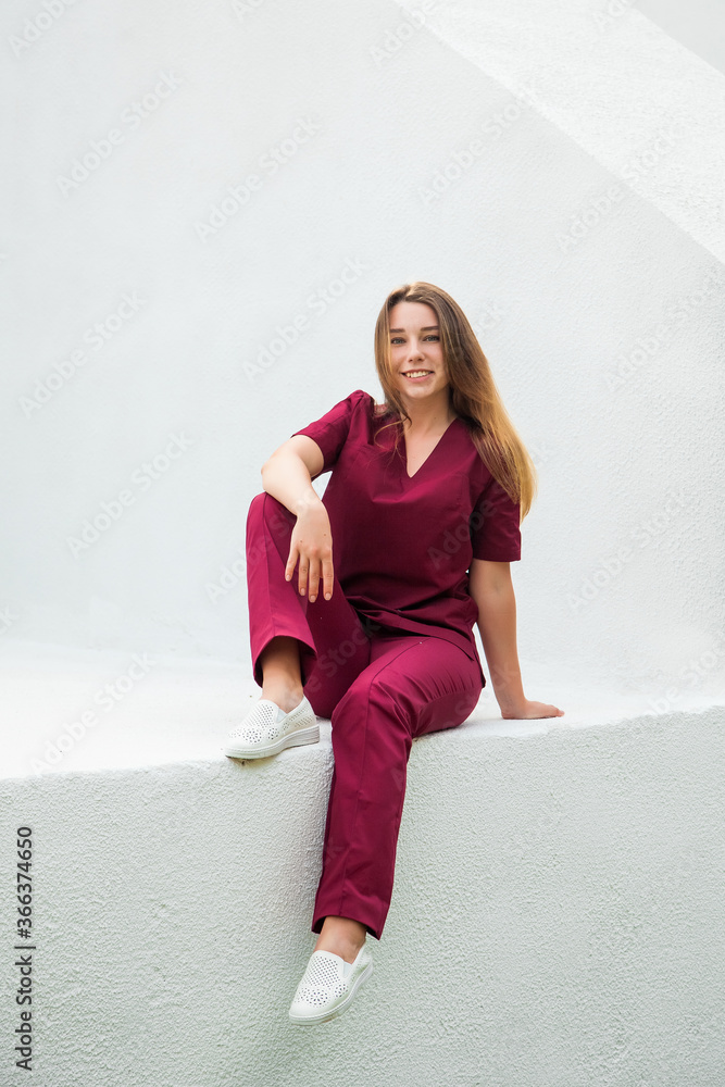 Medical students in burgundy red surgical suits standing in front of ...