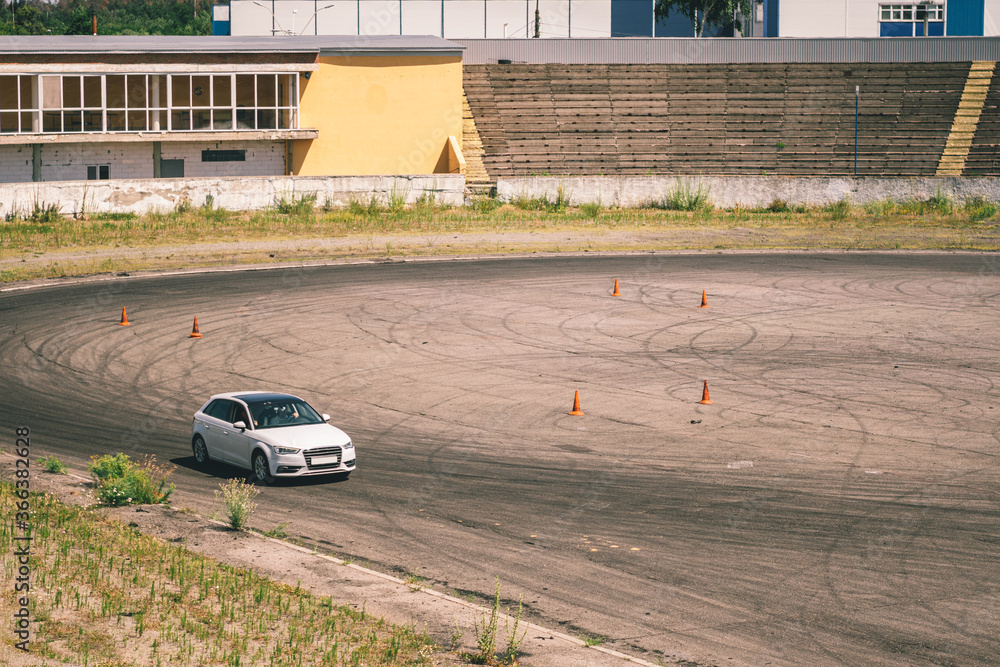 Car and traffic cones, driving school concept. Training car performs ...