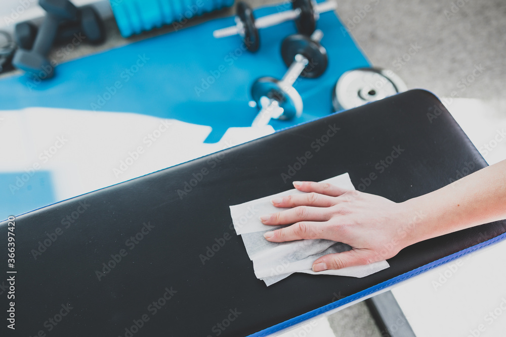 the new normal after covid-19, hand cleaning gym equipment with ...