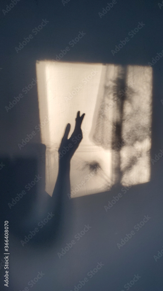 silhouette of human hand. Hand gesture shadow on rough wall surface ...