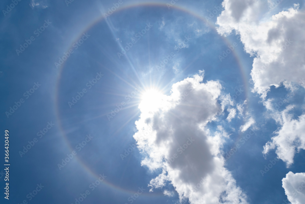 Sun halo phenomenon, circular rainbow around the sun on blue sky. Stock ...