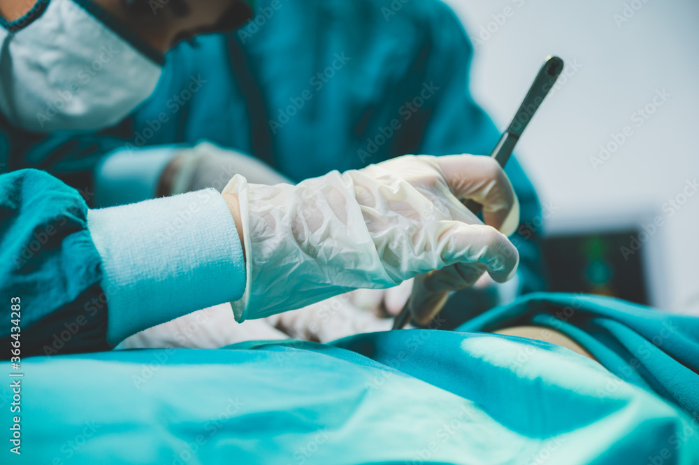 Medical team of surgeons in hospital doing invasive surgical ...