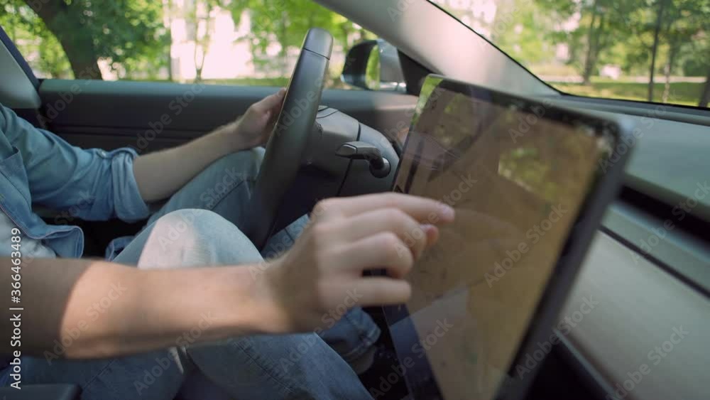 Tilt down and up side view shot of male driver using navigation map in ...