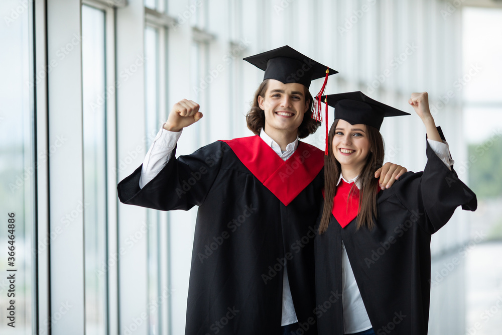 Happy couple of graduates showing diplomas and smiling, Complete high ...