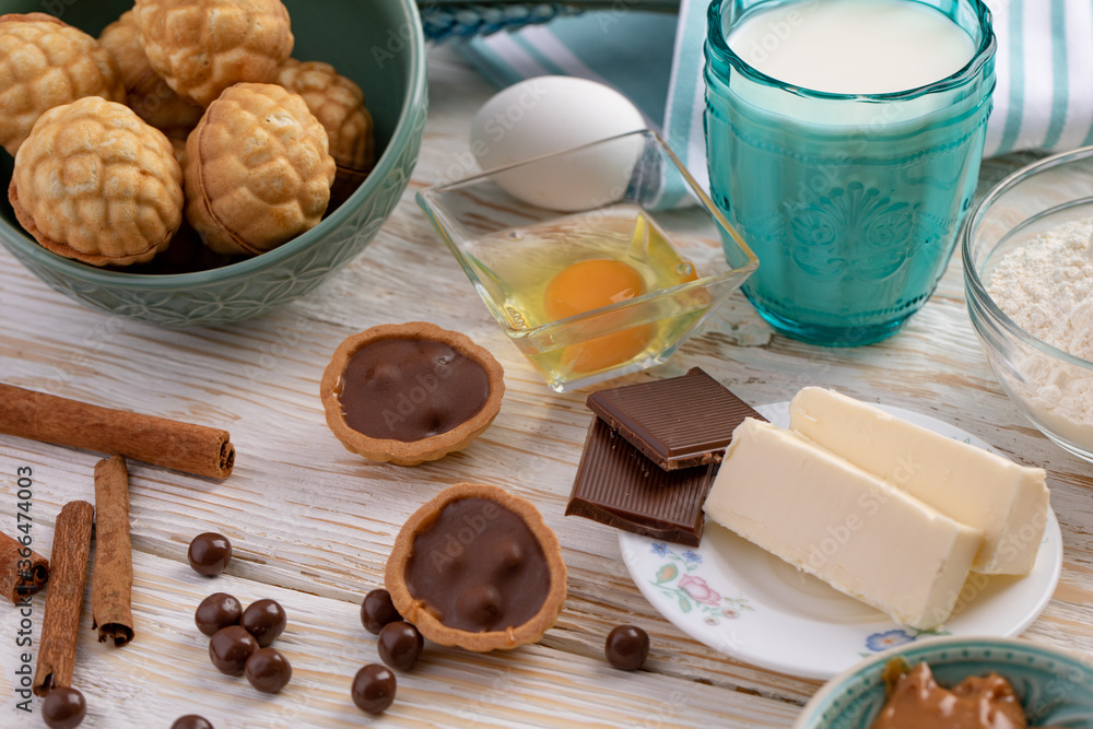 Ingredients for baking sweet cake with chocolate and nuts. egg, milk ...